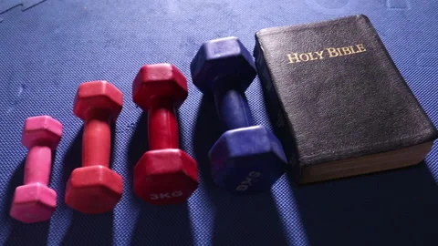 Colorful Gym Weights and Holy Bible | Stock Video | Pond5
