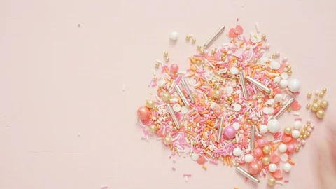 Colorful pink sprinkle blend on a pink b... | Stock Video | Pond5