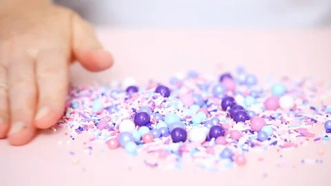 Colorful purple sprinkle blend on a pink... | Stock Video | Pond5