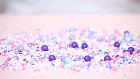 Colorful purple sprinkle blend on a pink... | Stock Video | Pond5