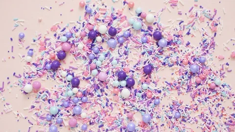 Colorful purple sprinkle blend on a pink... | Stock Video | Pond5