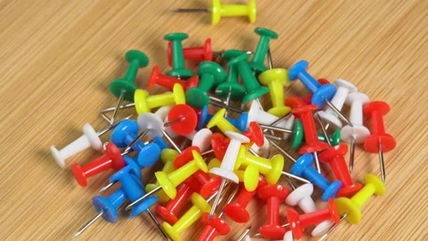 Colorful push pins rotating on the desk.... | Stock Video | Pond5