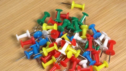 Colorful push pins rotating on the desk.... | Stock Video | Pond5