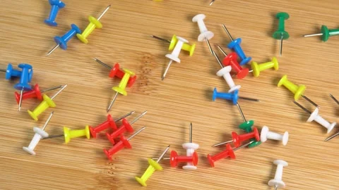 Colorful push pins rotating on the desk.... | Stock Video | Pond5