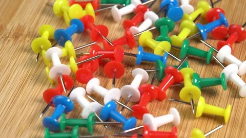 Colorful push pins rotating on the desk.... | Stock Video | Pond5