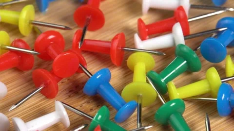 Colorful push pins rotating on the desk.... | Stock Video | Pond5