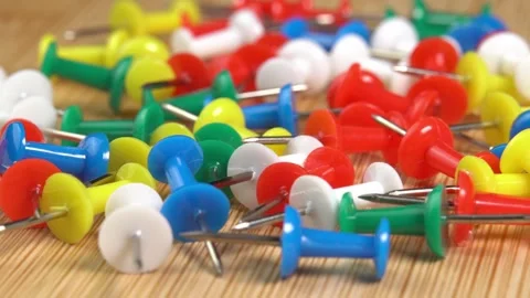 Colorful push pins rotating on the desk.... | Stock Video | Pond5
