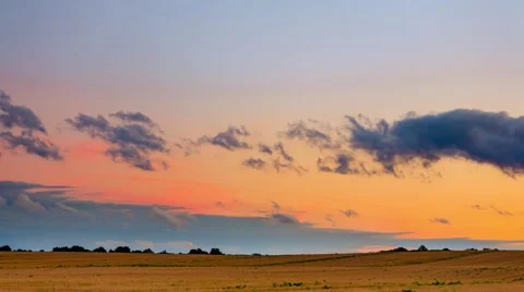 Colorful sunset over wheat field with mo... | Stock Video | Pond5
