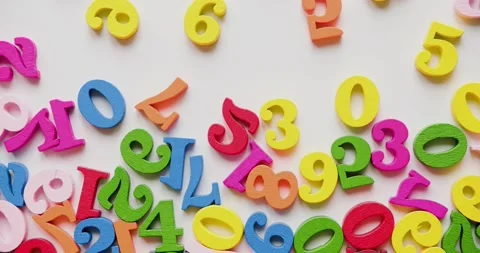 Colorful wooden numbers fill the backgro... | Stock Video | Pond5