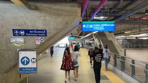 Commuters walking at skywalk MRT train s... | Stock Video | Pond5