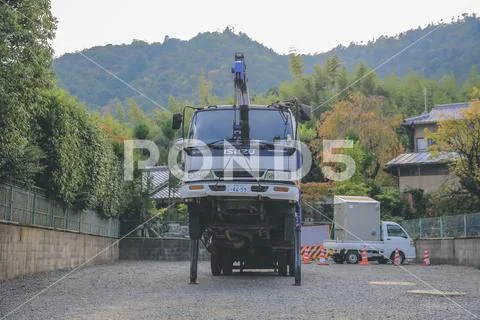 Compact mini hydraulic excavator with a rotating house platform and a ...