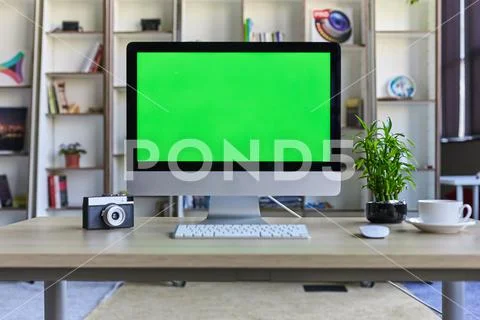 Computer desktop with mock-up green screen white background in office ...