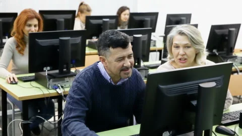 Computer lessons for adults. Group of pe... | Stock Video | Pond5