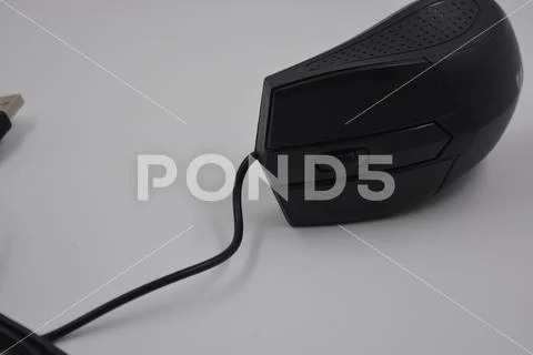 A computer, wired mouse with a long wire and a USB connection ...