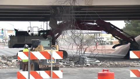 Concrete rubble falling though bridge on... | Stock Video | Pond5