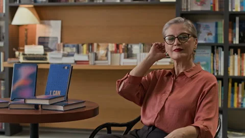 Confident Female Author Posing Beside He... | Stock Video | Pond5