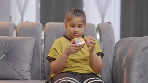 Confused Indian kid girl trying to solve... | Stock Video | Pond5