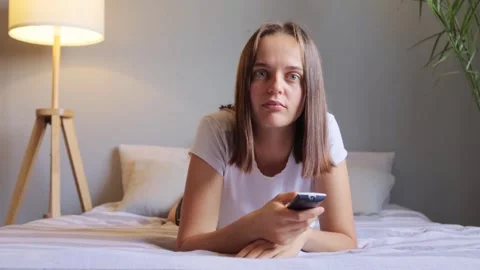 Confused woman gripping remote control w... | Stock Video | Pond5