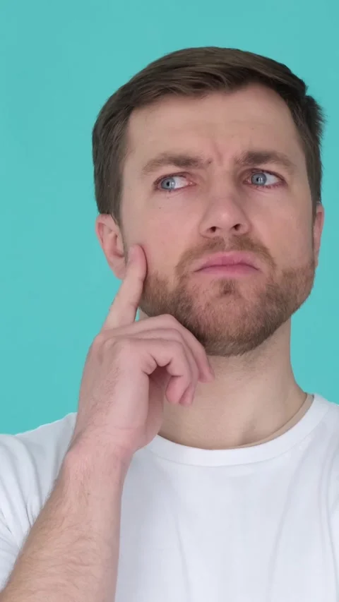 Confused young guy in white t-shirt scra... | Stock Video | Pond5