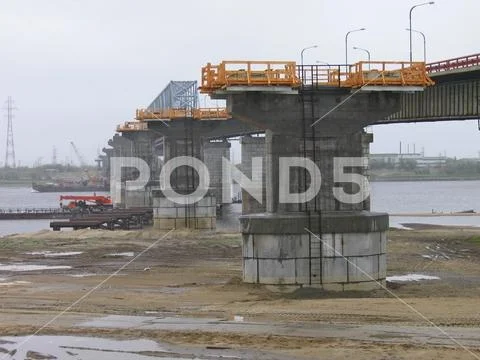 Construction of a reinforced concrete bridge across the river Stock ...