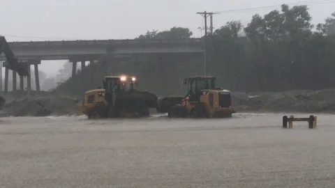 Construction team working in the rain | Stock Video | Pond5