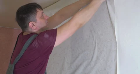 Construction worker applying wallpaper o... | Stock Video | Pond5