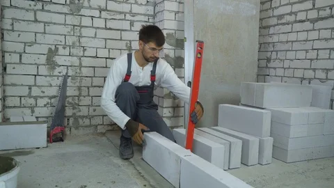 construction worker checking block layin... | Stock Video | Pond5