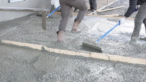 A construction worker in leveling an pou... | Stock Video | Pond5