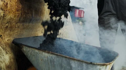 Construction worker loads hot tar into a... | Stock Video | Pond5