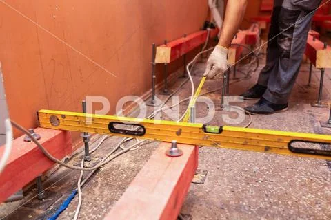 Construction worker measures distance between wooden blocks on the ...