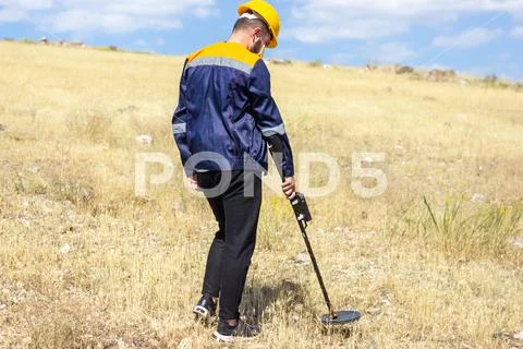 Photograph: Construction worker with metal detector #157558317