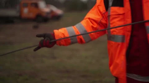 Construction worker pulling s steel cabl... | Stock Video | Pond5