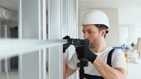 Construction worker screws the screw int... | Stock Video | Pond5