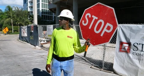Construction worker with stop sign provi... | Stock Video | Pond5