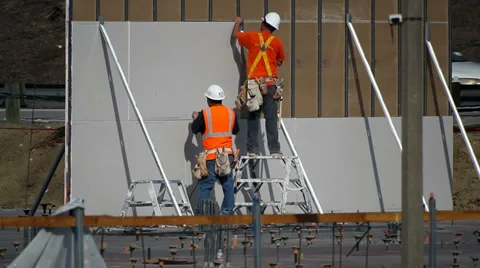 Construction workers install dry wall on... | Stock Video | Pond5