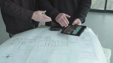 Construction workers looking over plans | Stock Video | Pond5