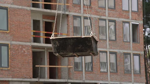 container with cement mortar is lifted b... | Stock Video | Pond5