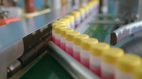 containers with red liquid and yellow ca... | Stock Video | Pond5