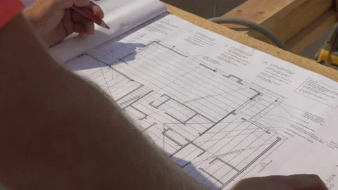 Contractor Works On Blueprints | Stock Video | Pond5