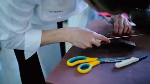 Cook cutting in half the fish at the tab... | Stock Video | Pond5