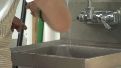 A cook thoroughly washes his hands under... | Stock Video | Pond5
