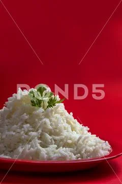 Cooked plain white basmati rice in a red plate on red background Stock ...