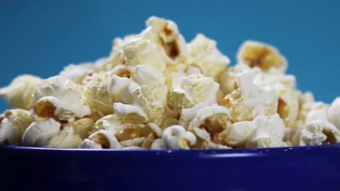 cooked popcorn in a plate on a blue back... | Stock Video | Pond5