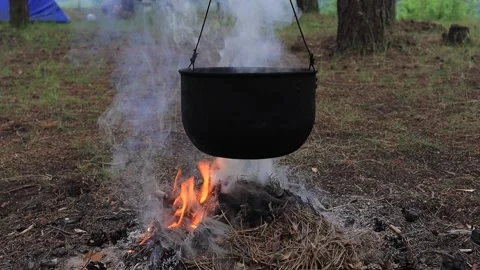 Cooking cauldron hanging over a fire, or... | Stock Video | Pond5