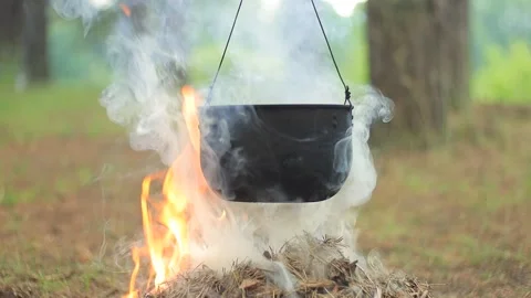 Cooking cauldron hanging over a fire, or... | Stock Video | Pond5
