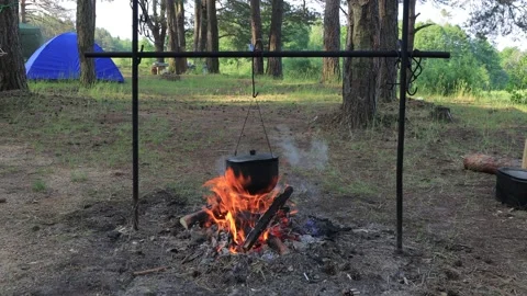 Cooking cauldron hanging over a fire, or... | Stock Video | Pond5