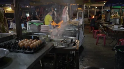 Cooking with flame on the asian food str... | Stock Video | Pond5