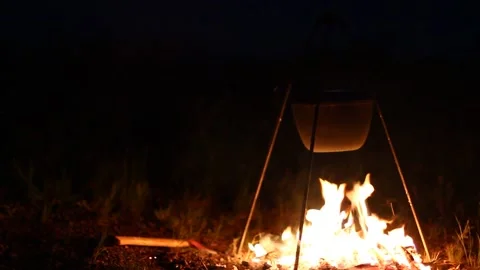 cooking in a pot on a campfire night tri... | Stock Video | Pond5
