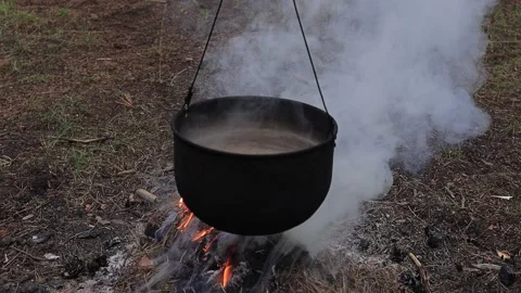 cooking pot hanging over a fire. Thick f... | Stock Video | Pond5