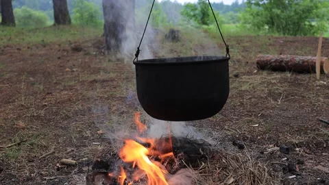 cooking pot hanging over a fire. Thick f... | Stock Video | Pond5